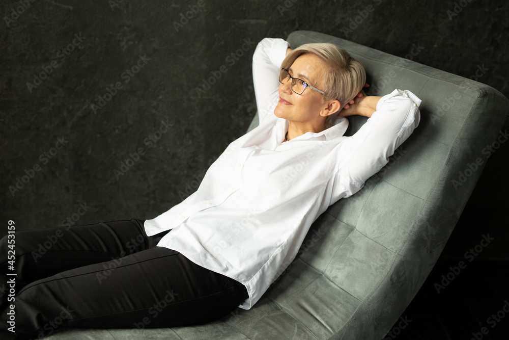 comfortable rest in a chair lying on the sofa of a stylish woman of the ...