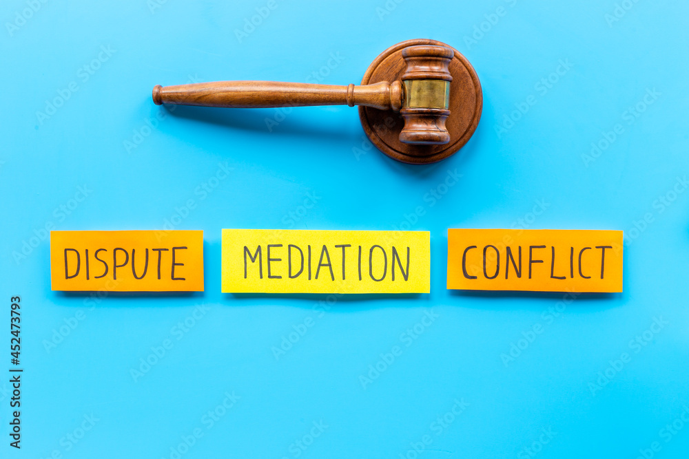 Word mediation on office table between conflict and dispute. Top view ...