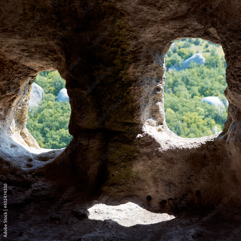 Ancient cave city. Inside the cave, view from the window. Medieval ...