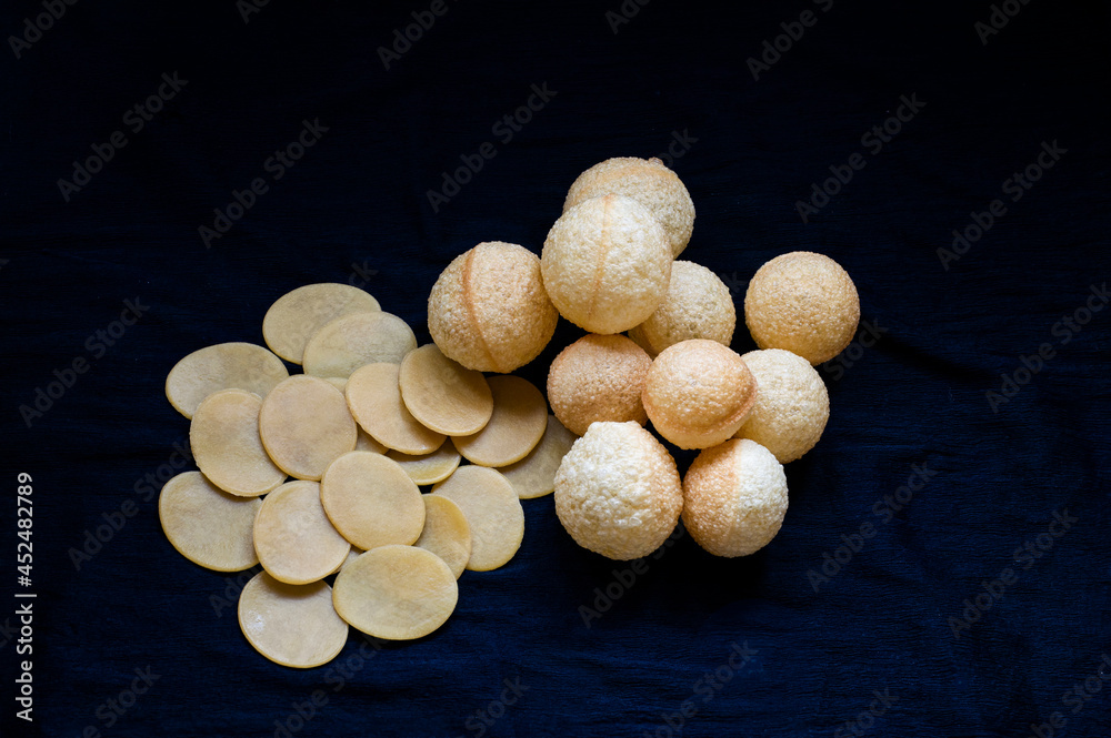 Stock photo of raw panipuri papad and fried puri kept on black ...