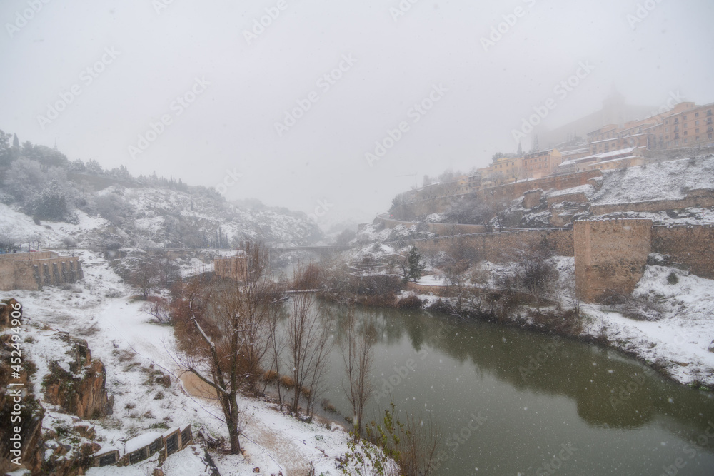 City landscape of snowy old city and castle with clouds and fog; View ...