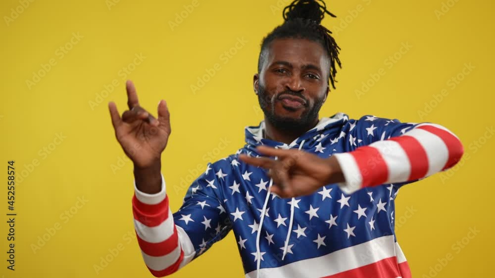Joyful dance of happy African American man at yellow background ...