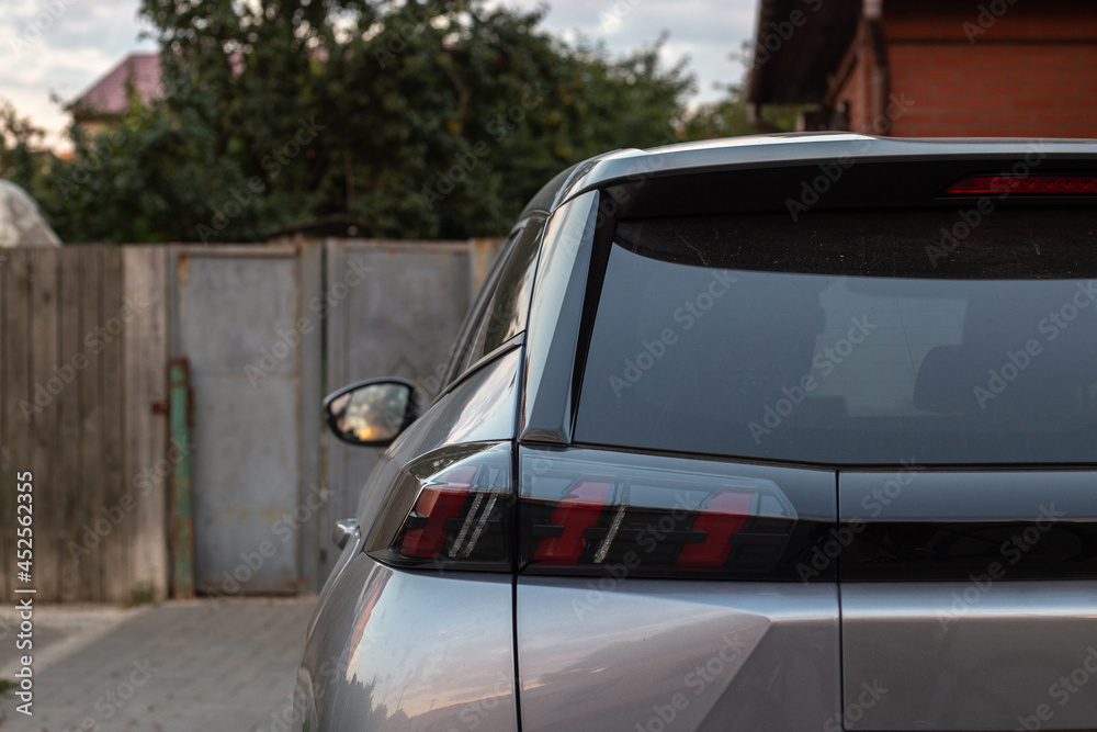 Back window of grey car parked on the street in summer sunny day, rear ...