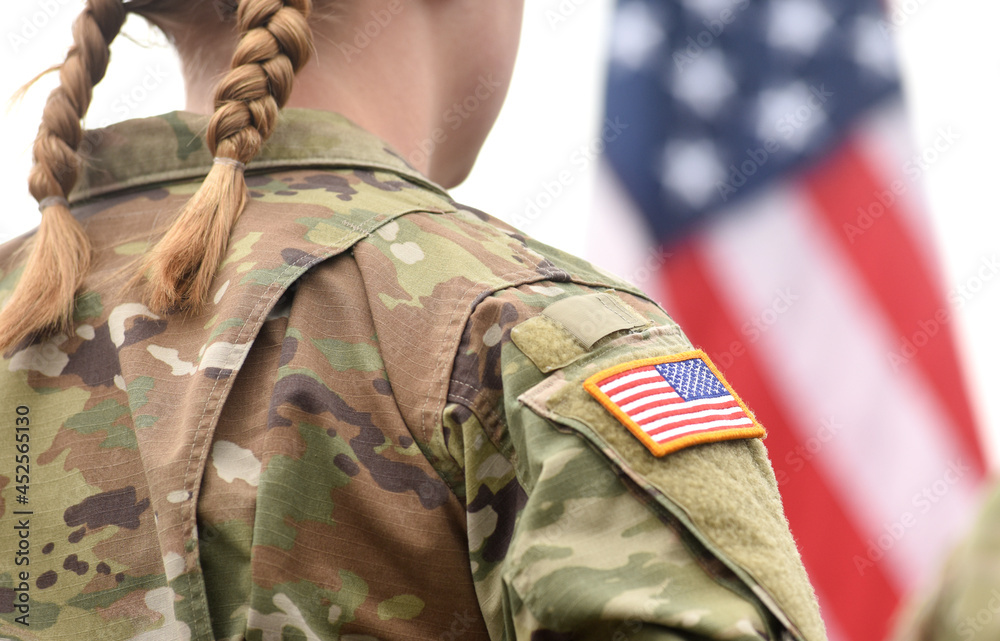 American Soldiers looks on the US flag. US Army. Military forces of the ...