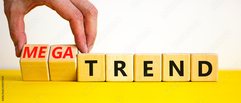 Trend or megatrend symbol. Businessman turns wooden cubes and changes ...