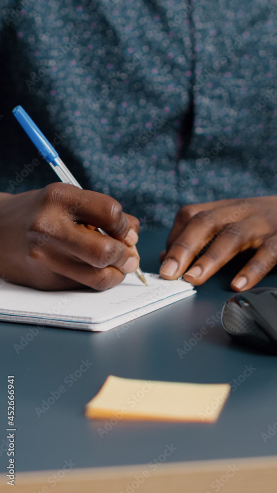 Closeup african american black man hands taking notes on notepad using ...