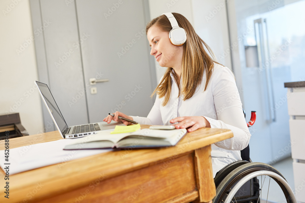 Paralyzed student in a wheelchair doing e-learning at home Stock Photo ...