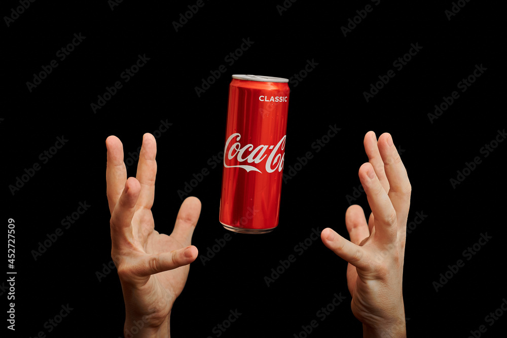 Hands catch Coca Cola can, black background Stock Photo | Adobe Stock