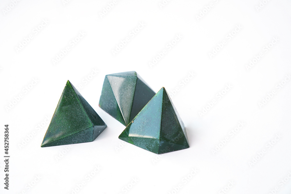 Luxury pyramid shaped chocolate candy. Three chocolates - green color ...