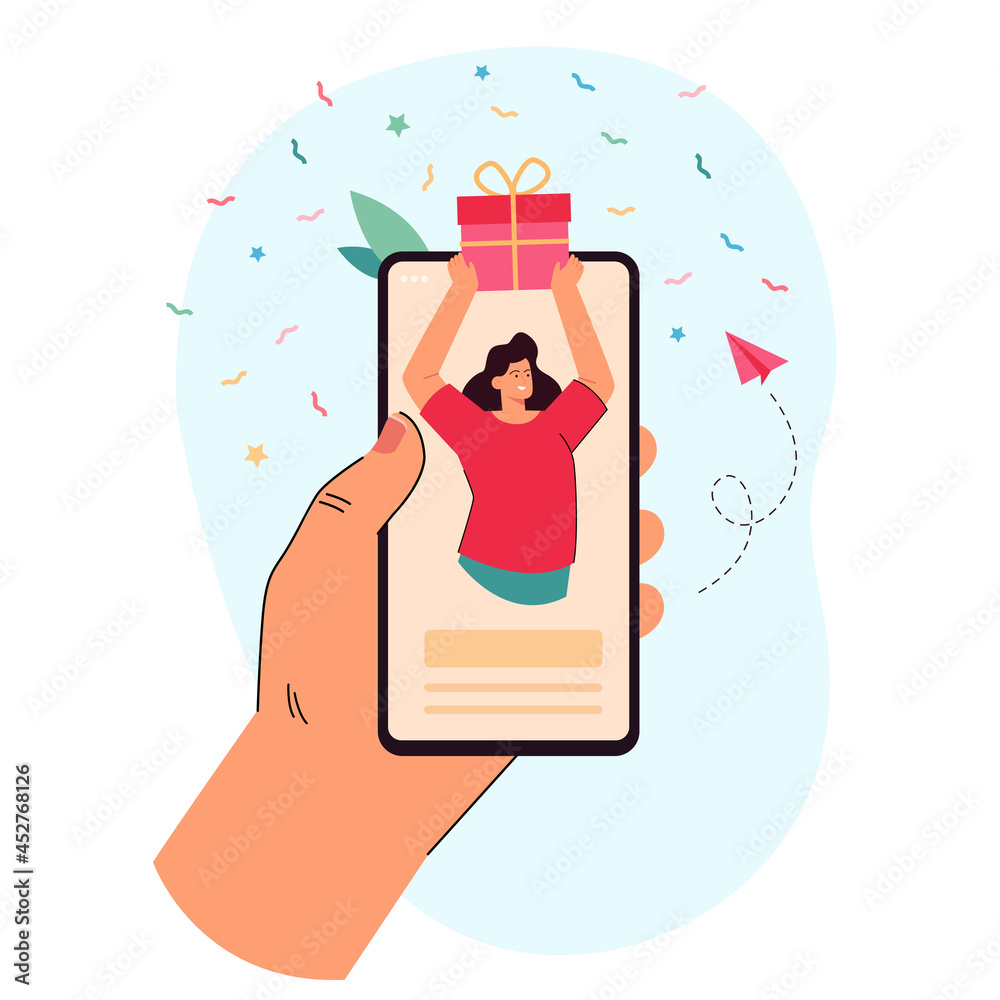Hand holding phone with happy woman lifting gift box on screen. Person ...