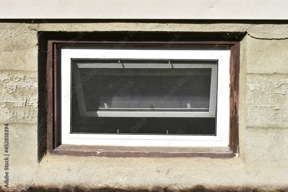 An image of an old basement window with brown painted trim. Stock Photo ...