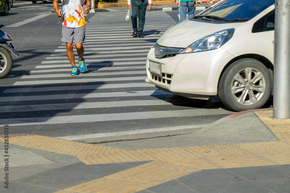 crossing the road on the crosswalk. Vehicles should stop for ...
