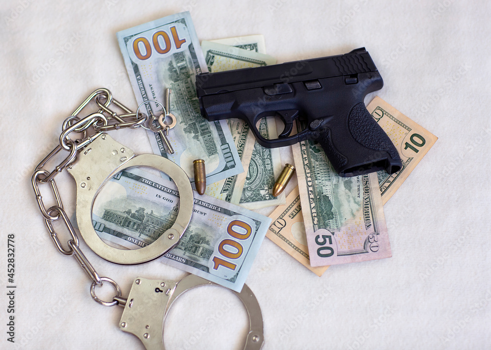 Pistol gun and bullets 9mm ammunition, handcuffs and American dollar ...