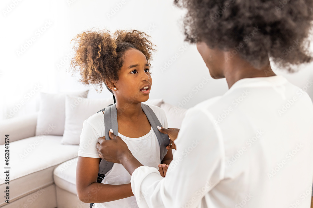 Getting ready for school. Shot of a mother getting her child ready for ...