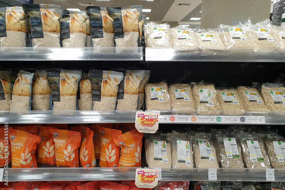 Various brands of healthy organic oats display on the store shelf ...