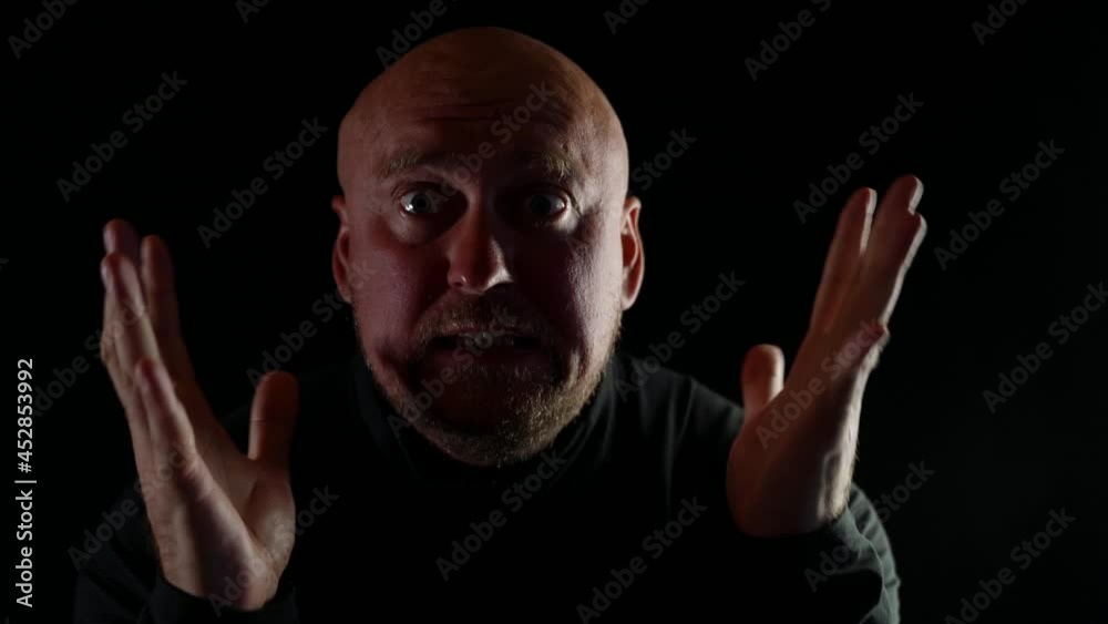 Portrait of a bald man, an angry guy shouting directly into the camera ...
