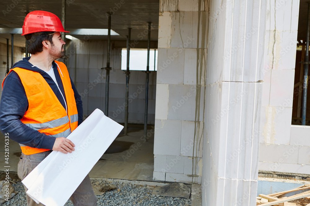 Foreman with blueprint controls building shell construction site Stock ...