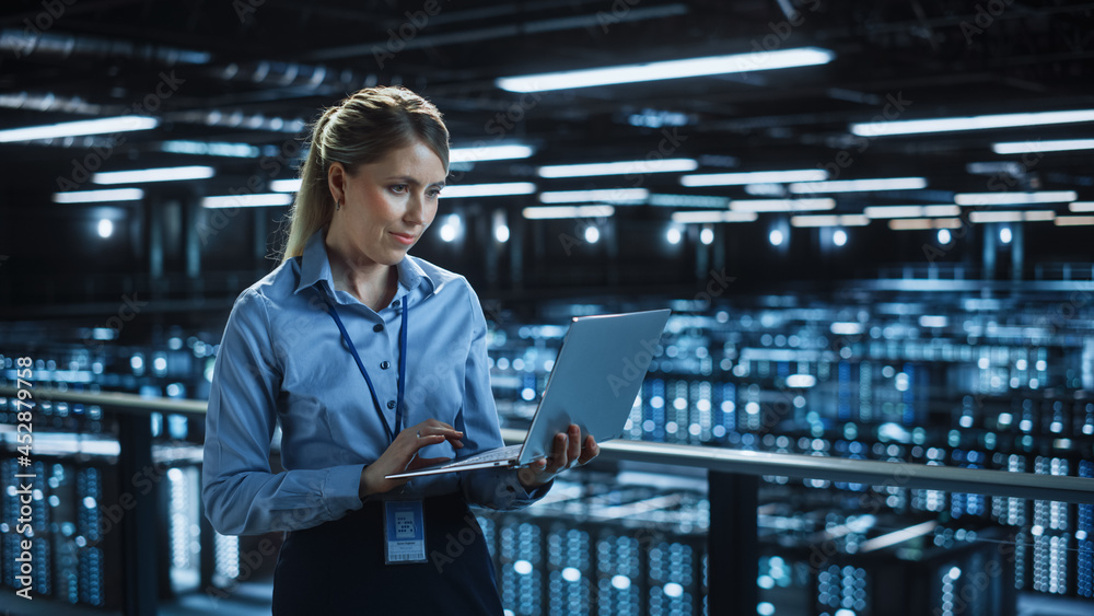 Portrait of IT Specialist Using Laptop in Data Center. Big Server Farm ...