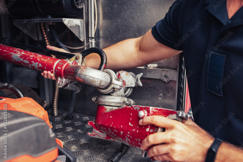 Firefighter holding fire hydrant for emergency firefighting. Concept of ...