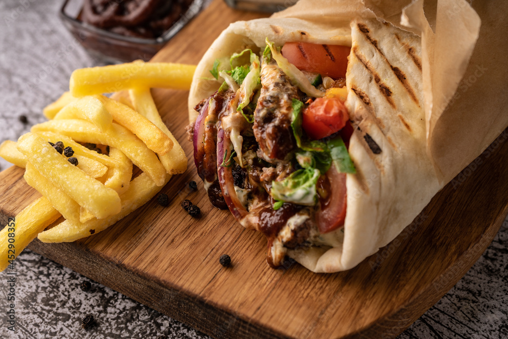 doner kebab, a shawarma in a pit of fresh vegetables and meat. with ...