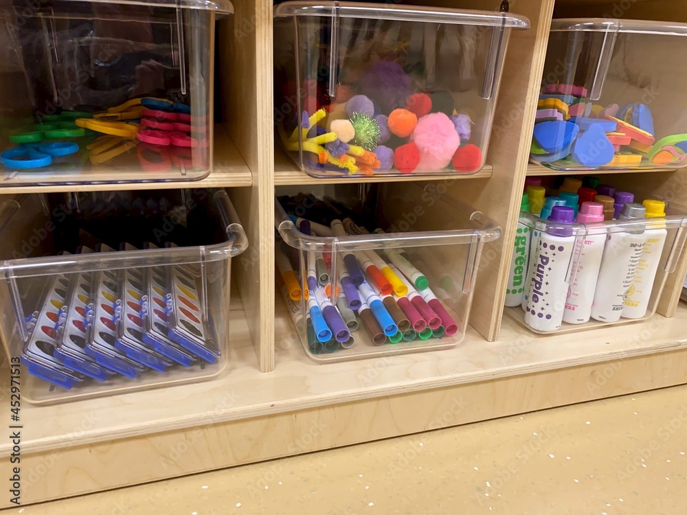 Early childhood education preschool classroom. Wooden shelves with art ...