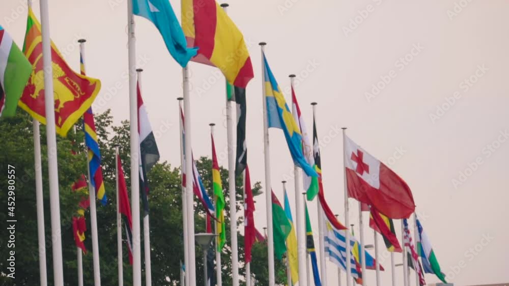 Flags of the countries of the world on flagpoles flutter in the wind ...