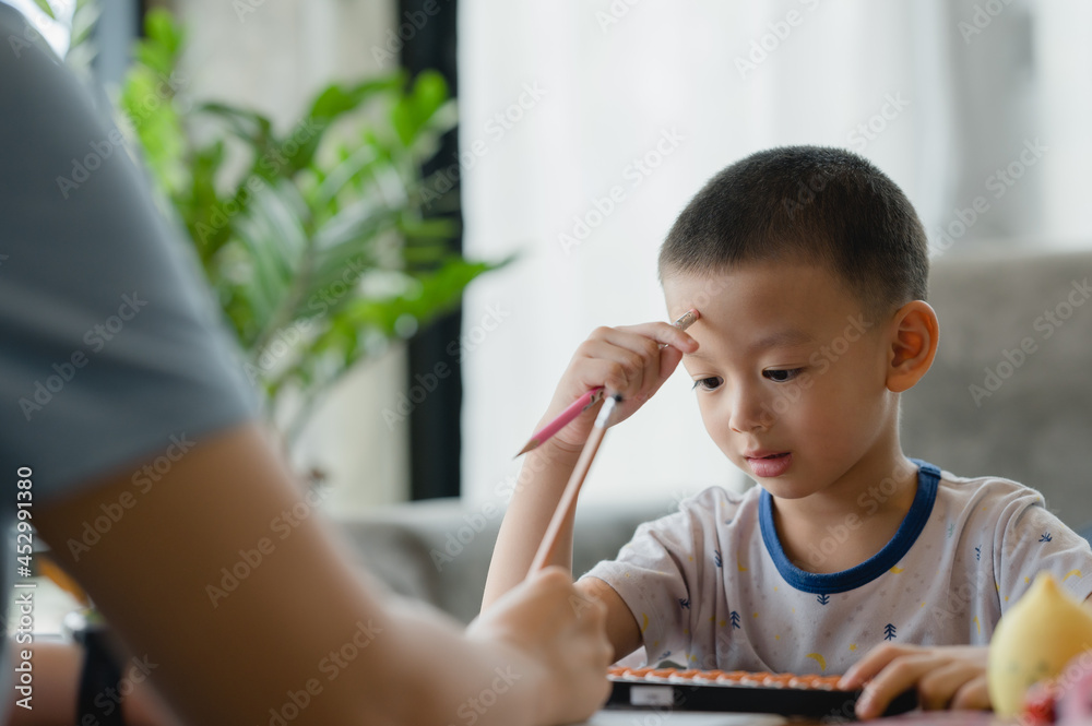 Foto de Asian child boy Learning math with an abacus, education concept ...