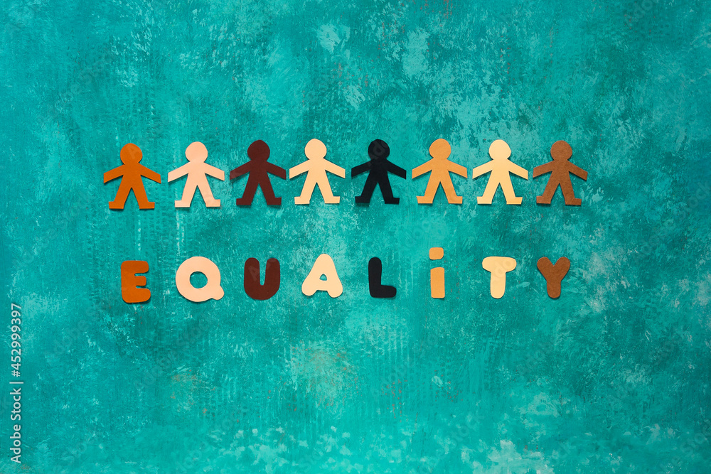 The word EQUALITY and a paper dolls chain of different skin colors ...