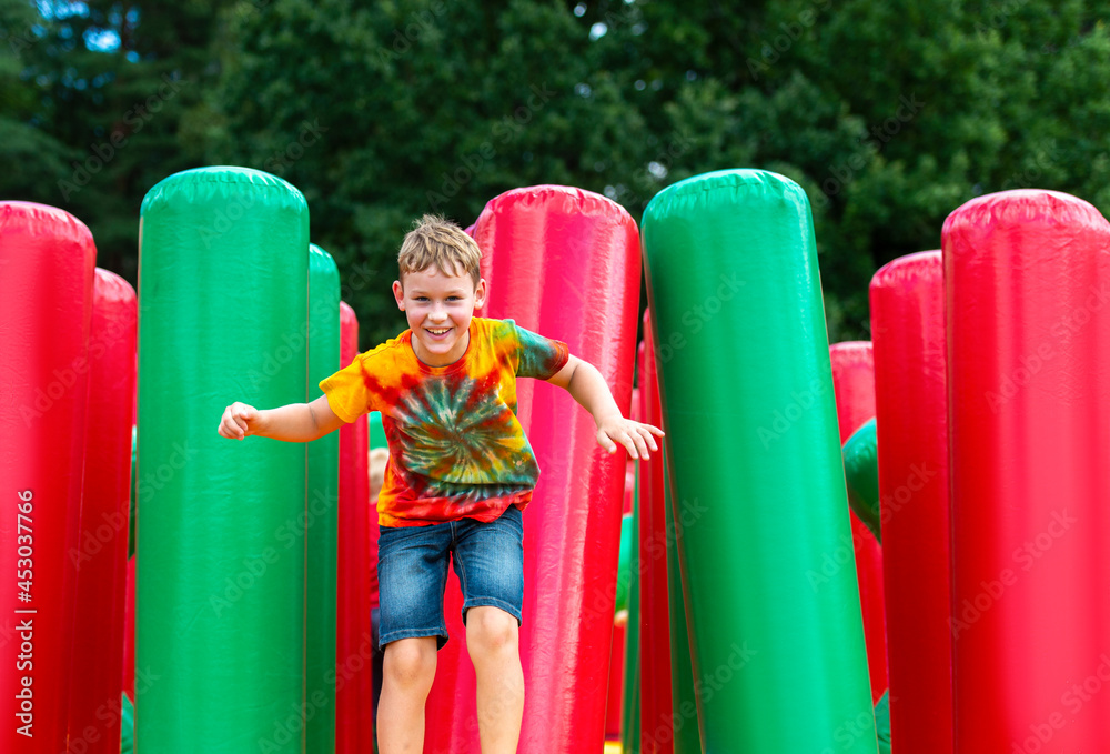 Child jumping on colorful playground trampoline. Kids jump in ...