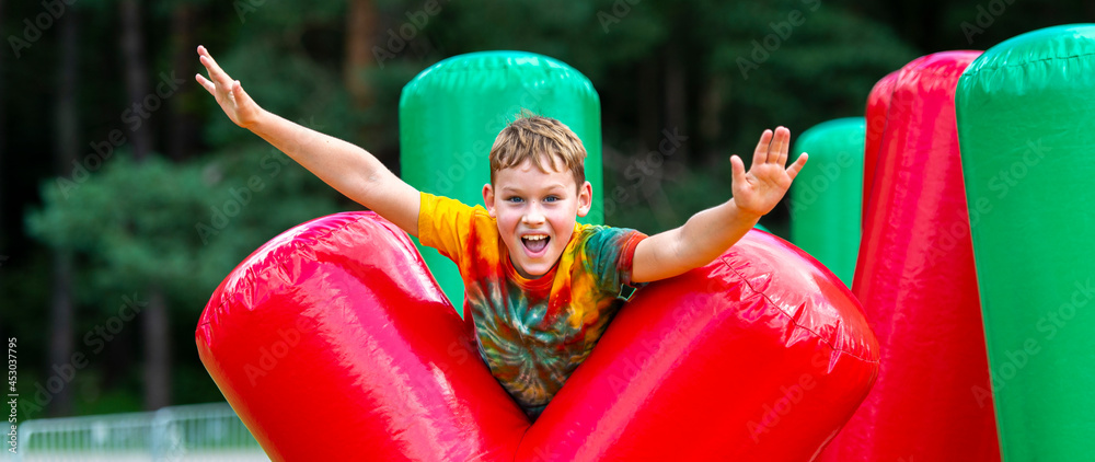 Child jumping on colorful playground trampoline. Kids jump in ...