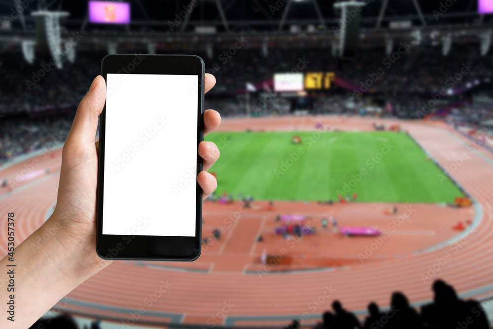 Hand holding mobile phone with blank screen sports stadium Stock Photo ...