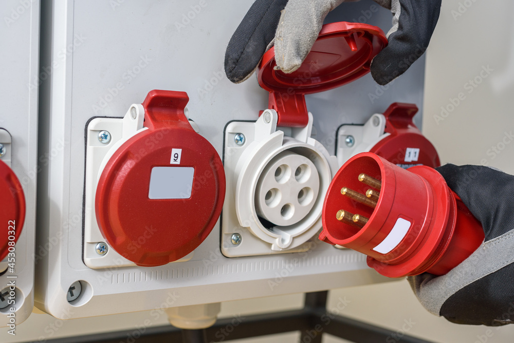 Industrial sockets and plug on distribution board. Construction site ...
