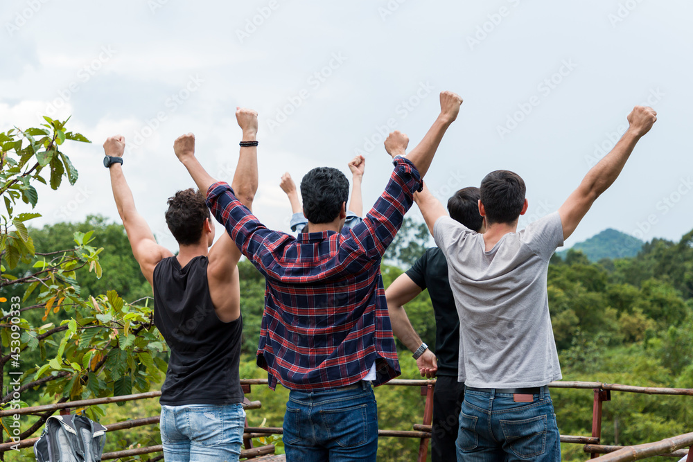Group of male hiking and camping. Back view of group of young tourists ...