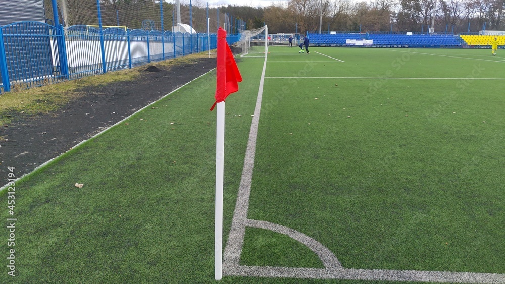 The corner flag is placed on the artificial football field of the city ...