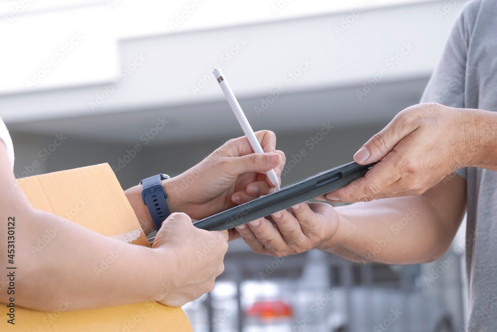 Woman hand using electronic pen to sign signature on tablet screen ...