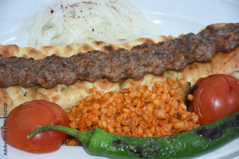 Turkish kebab with bulgur pilaf, roasted tomatoes, roasted peppers ...