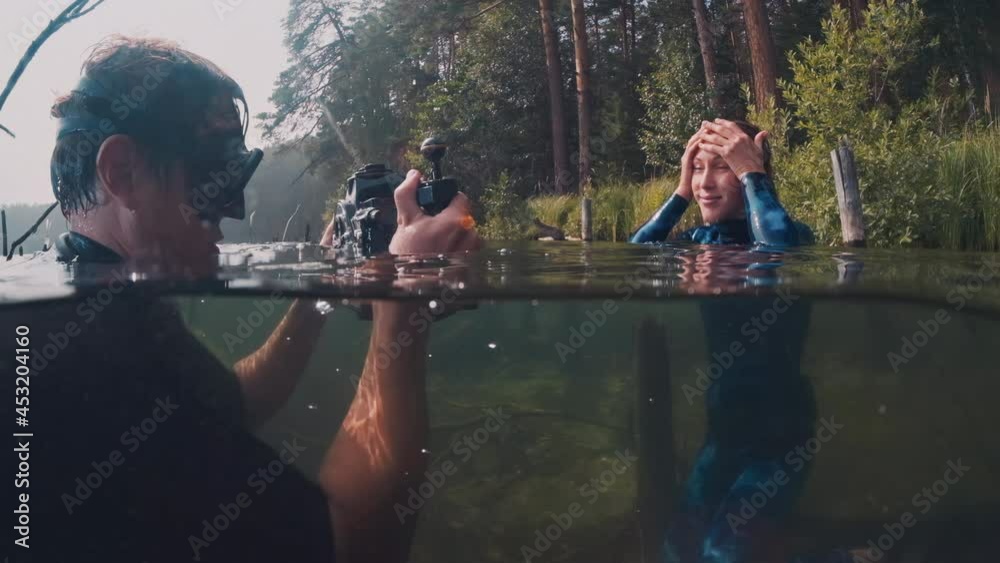 Fashion underwater photographer. Male photographer takes picture of the ...