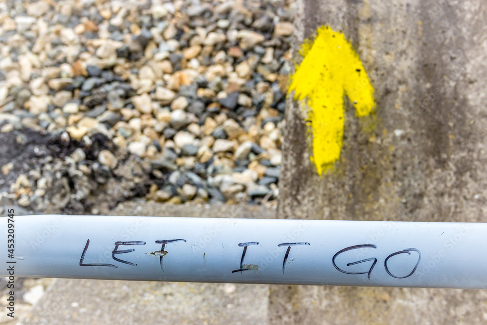 Motivational Writing on a Railing next to the Yellow Arrow Symbol of ...