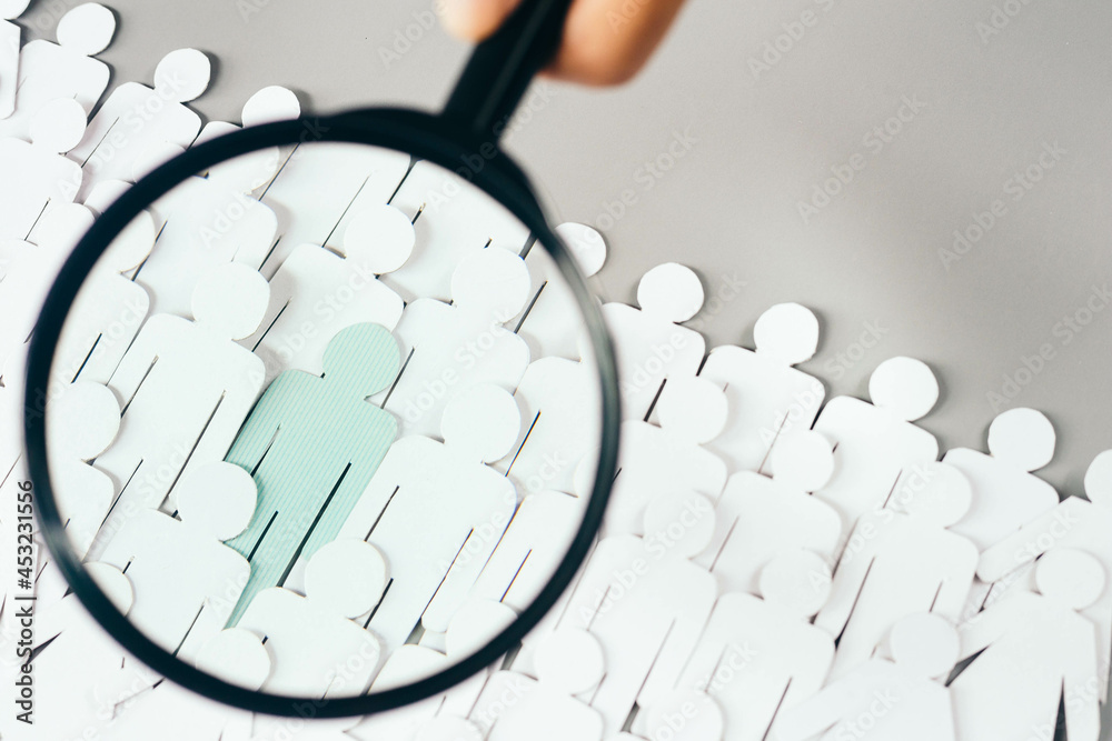 Selecting employees from the crowd to suit the job. Magnifying glass ...