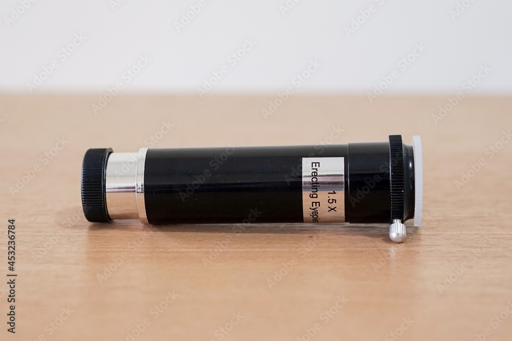 Image erector or 1,5x erecting image. Telescope parts on wooden table ...