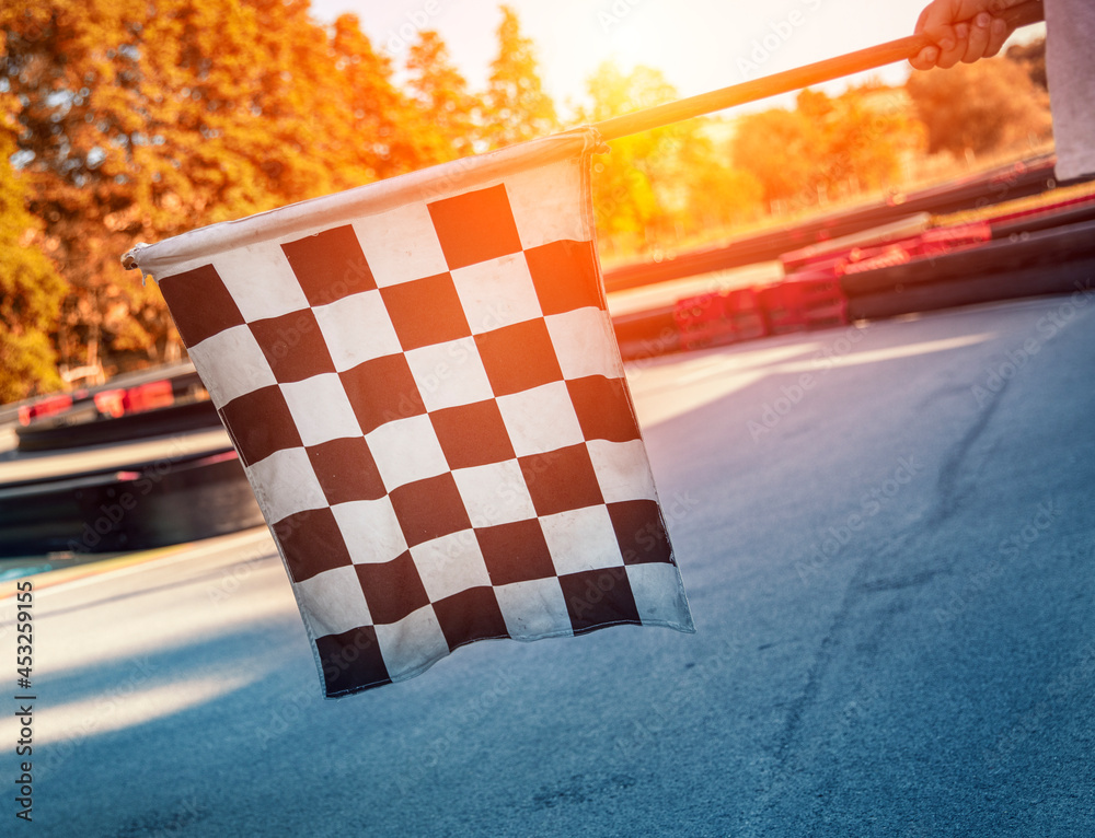Checked flag at motorsport race track Stock Photo | Adobe Stock