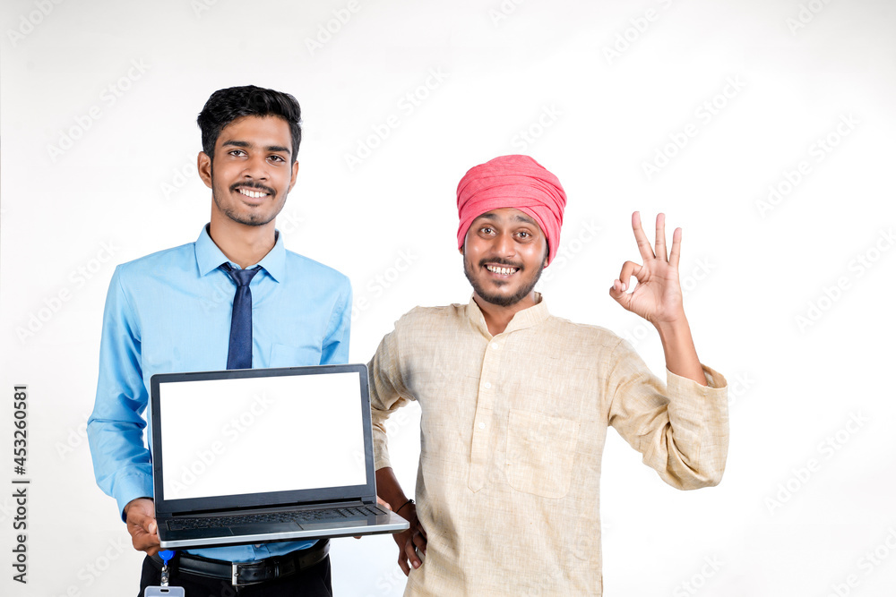 Young indian officer showing laptop screen with farmer on white ...