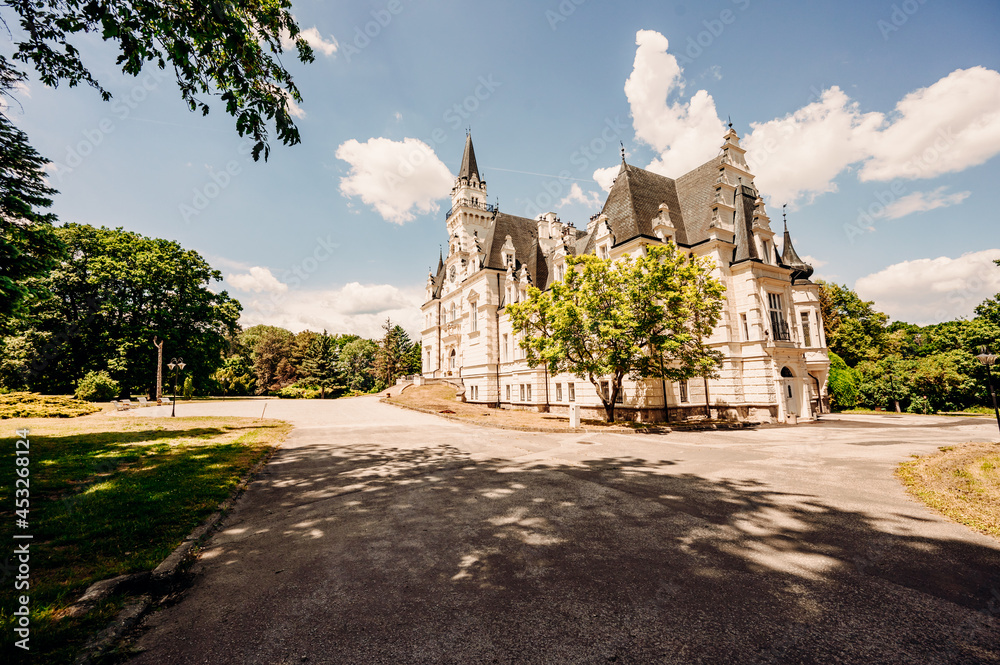 Budmerice Castle from 19th century in nature landscape. Tree in forest ...