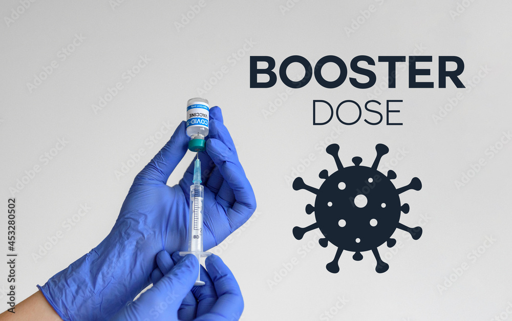 Medical worker holding covid syringe and vaccine in front of white ...