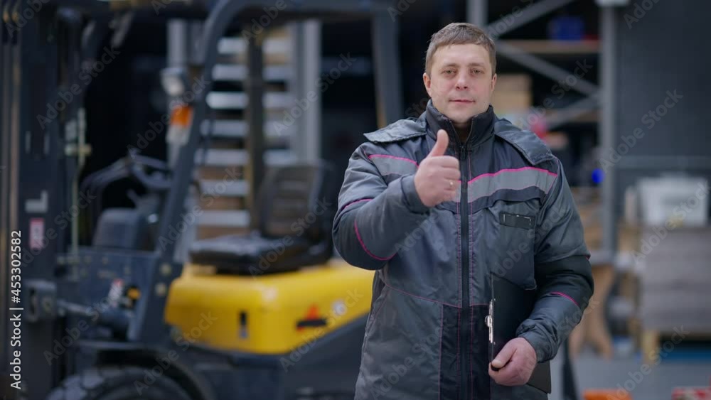 Positive confident man showing thumb up looking at camera smiling ...