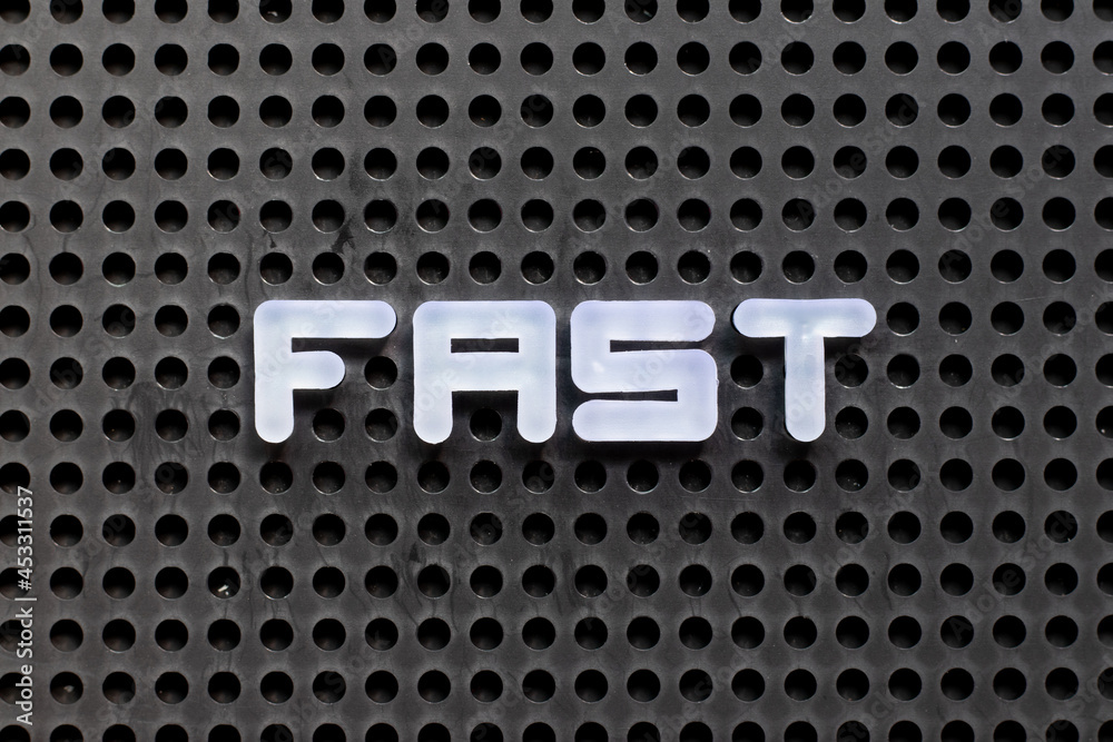 White color letter in word fast on black pegboard background Stock ...
