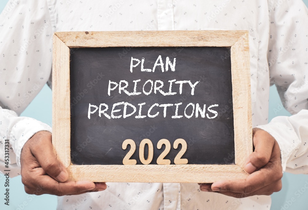 Plan Priority and Predictions concept for the year 2022. Man holding ...