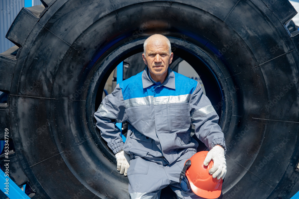 Bulldozer driver coal mine in uniform with helmet and headphones ...