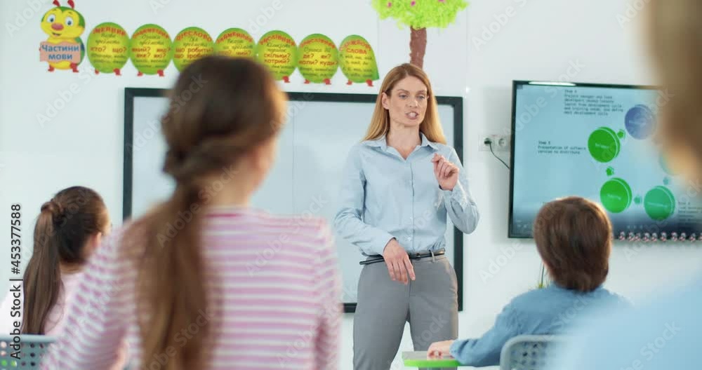 Caucasian young beautiful female teacher at work speaking while ...