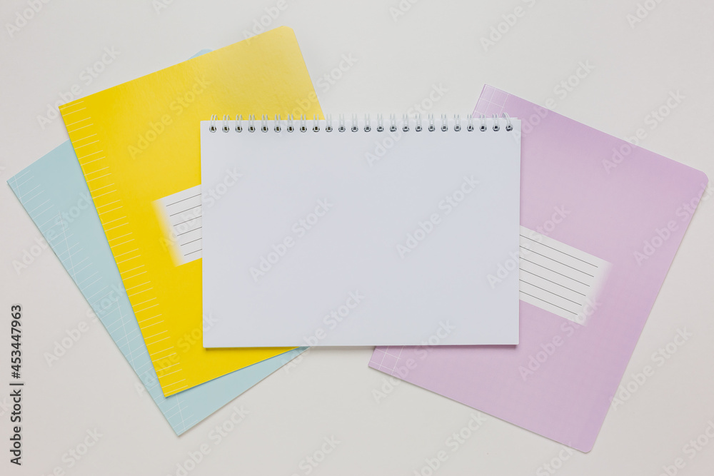 Notepad and exercise book on the desk. Mock up in copy space office on ...